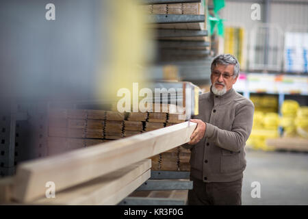 Man choosing and buying construction wood in a DIY store for his DIY ...