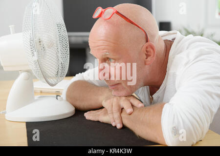 mature man refreshed with a fan Stock Photo - Alamy