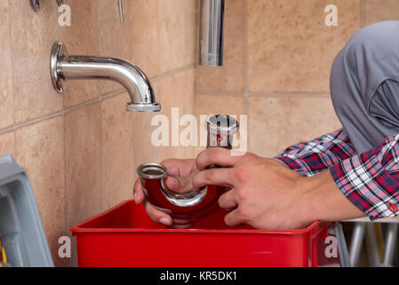 Plumber's Hand Fixing Sink In Bathroom Stock Photo - Alamy
