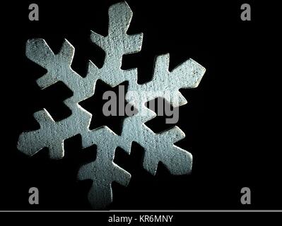 Huge white wooden snowflake and black background Stock Photo - Alamy