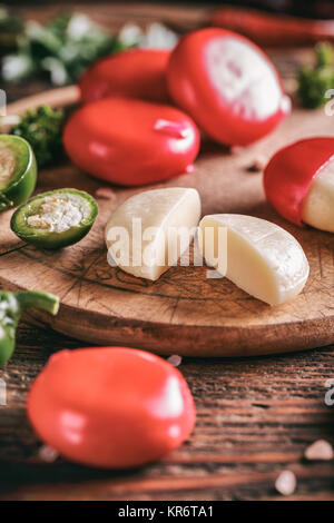 Babybel cheese in red wax cover with wedge sliced off Stock Photo - Alamy
