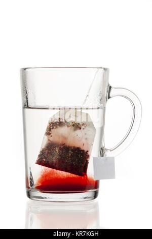 Dipping tea bag in hot water on white background Stock Photo - Alamy