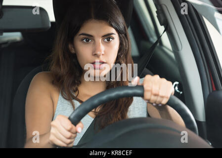 Serious anxious woman driving car. Female driver of middle age pensive ...