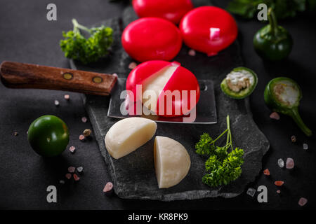 Babybel cheese in red wax cover with wedge sliced off Stock Photo - Alamy