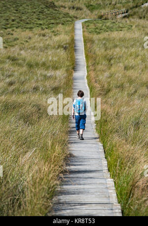 Ireland, Cavan County, Cuilcagh Mountain Park, Woman hiking along road ...