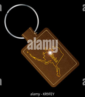 Image of gold house key fob and key, hanging in front of blurred house ...