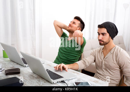 Two workmates teaming up and working together Stock Photo - Alamy