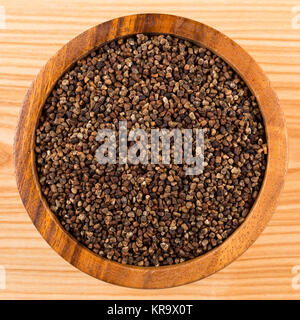 Decorticated cardamom seeds in a wooden spoon on white background Stock ...