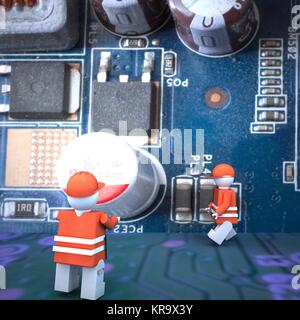 Worker puppet on a computer motherboard Stock Photo - Alamy