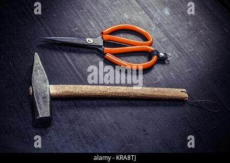 Hammer and scissors to the desktop Stock Photo - Alamy