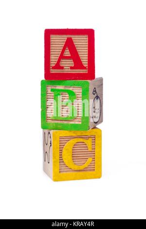 ABC Alphabet blocks stacked up on yellow background Stock Photo - Alamy