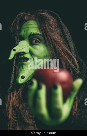 Evil witch holding a rotten apple Stock Photo - Alamy