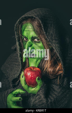 Evil witch holding a rotten apple Stock Photo - Alamy
