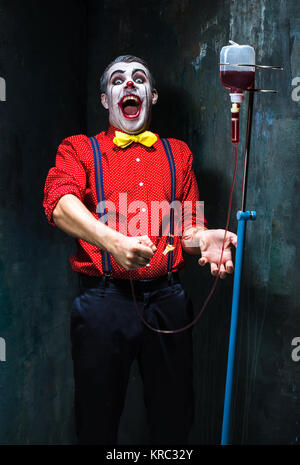 The scary clown and drip with blood on dack background. Halloween ...