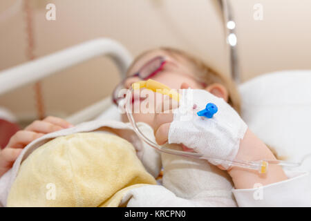 Little girl is receiving medication through intravenous fluid therapy ...