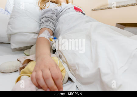 Little girl is receiving medication through intravenous fluid therapy ...