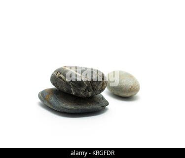 Three gray stones stacked on each other. Isolated on a white background ...