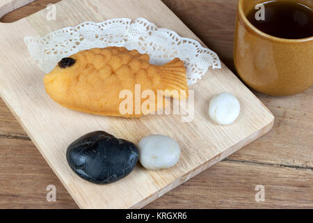 A taiyaki, a Japanese fish-shaped cake filled with red bean paste, from ...