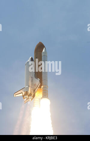 Space shuttle Atlantis' twin solid rocket boosters ignite to propel the spacecraft off Kennedy ...