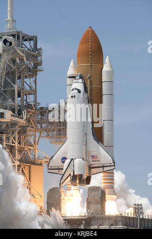 Space shuttle Atlantis' twin solid rocket boosters and three main engines ignite to propel the ...