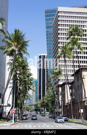 The view of straight street with tall palms in Honolulu downtown ...