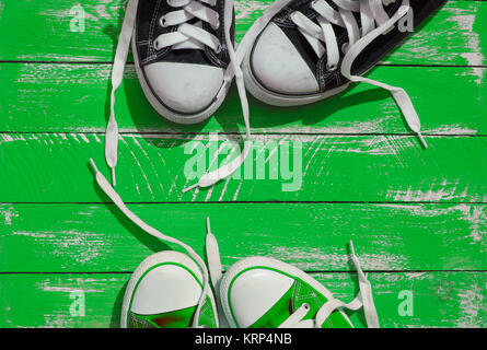 Pairs Of Old Textile Green Classic Sneakers Stand On A Gray Wooden Background Top View Copy
