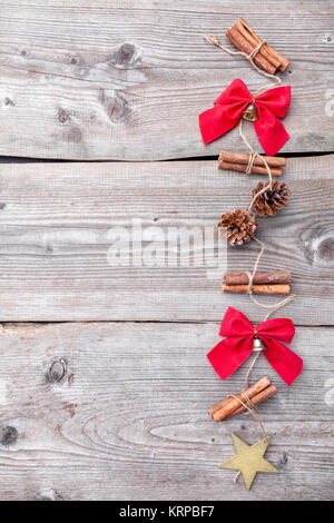 Christmas bells hang as a decor on the Christmas ribbon on the brick ...
