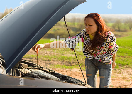 young woman bent over car engine Stock Photo - Alamy