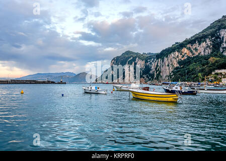 a harbor with boats and a green island under the clear sky Stock Photo ...