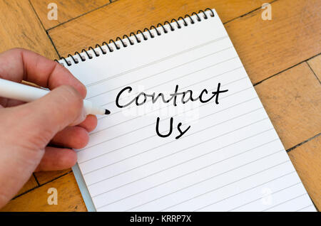 Contact us concept on notebook Stock Photo - Alamy