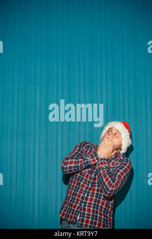 frightened christmas man wearing a santa hat Stock Photo - Alamy
