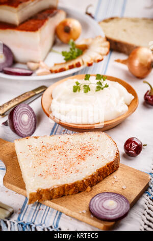 Lard bread with red paprika powder on rustic table Stock Photo - Alamy