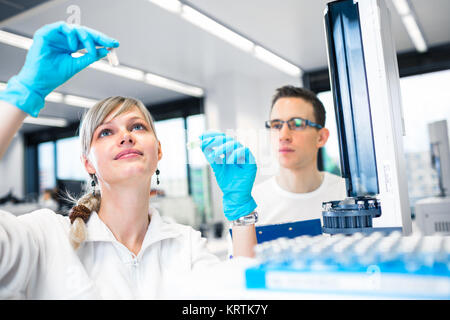 Two young researchers carrying out experiments in a lab Stock Photo - Alamy