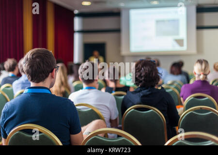 Audience in lecture hall participating at business event Stock Photo ...