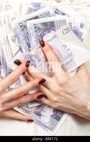 Female hand holding British pounds currency isolated with clipping path ...