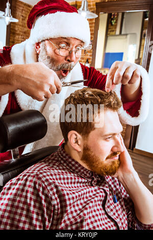Santa claus as master at barber shop Stock Photo - Alamy