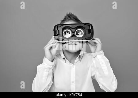 Kid looking at camera through VR glasses Stock Photo - Alamy