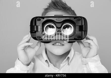 Kid looking at camera through VR glasses Stock Photo - Alamy