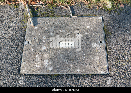 Cable TV access cover in pavement Stock Photo - Alamy