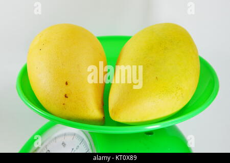 mango on green weighting scale tray Stock Photo - Alamy