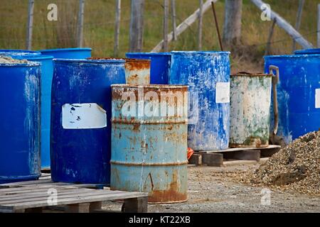 Abandoned and rusty barrels of gasoline, oil in an attractively colored ...