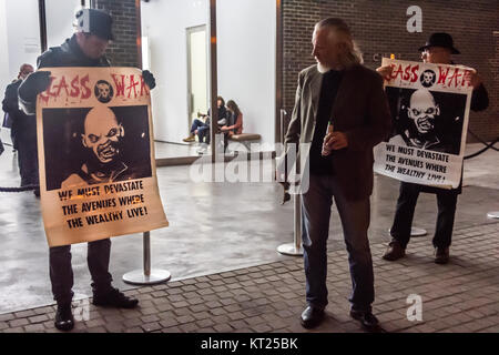 Simon Elmer & Ian Bone stand holding Class War posters at the entrance ...