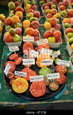 Sliced arrangement of colorful heirloom tomato types on display at ...