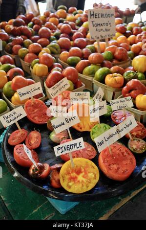 Sliced arrangement of colorful heirloom tomato types on display at ...