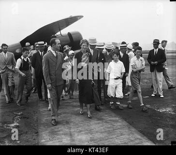 Amelia Earhart, a pioneering American aviator, is seen preparing for ...