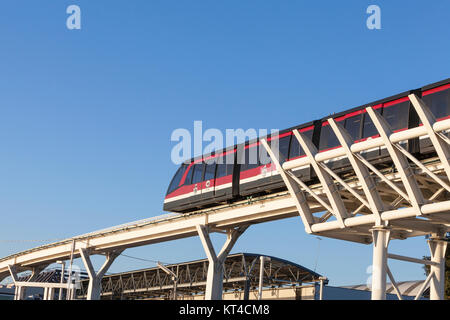 Elevated monorail train on rail. Guide wheels rubber tire on concrete guideway beam with ...