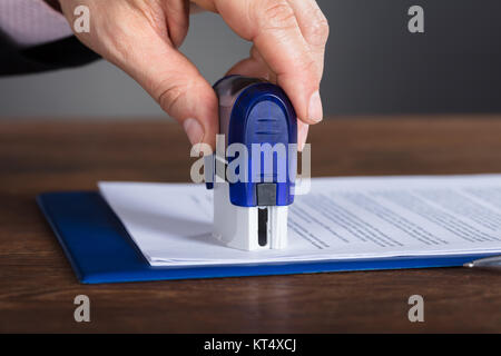 Person's Hand Stamping Document Stock Photo - Alamy