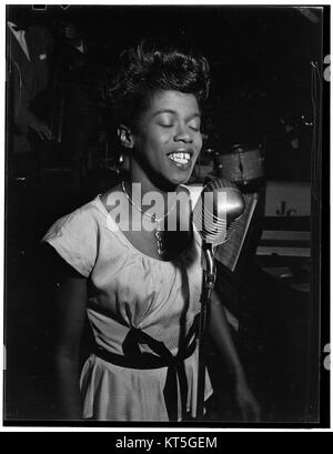 This photograph captures Sarah Vaughan, a legendary jazz singer ...