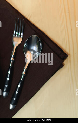 wooden cutlery fork and spoon on a chopping board on table Stock Photo ...