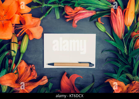 Flowers composition. Wreath made of orange flowers and green leaves on ...